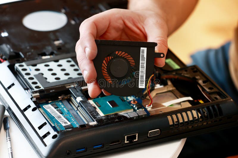 Fixing Laptop. Repairman Holds Cooling Fan and Repairs from Overheating ...