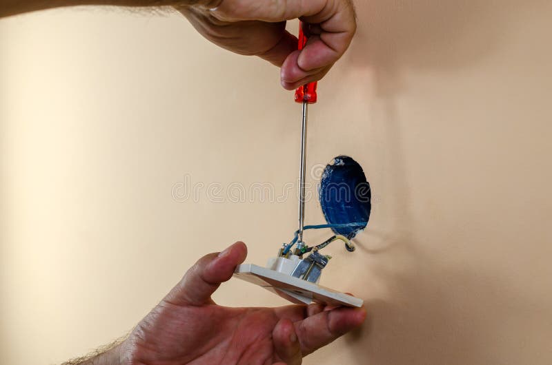 Fixing light switch stock photo. Image of attaching - 185332640