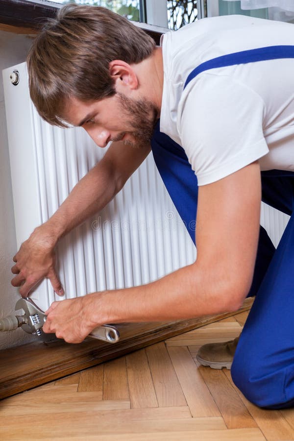 Fixing radiator at home stock photo. Image of repair - 45620194