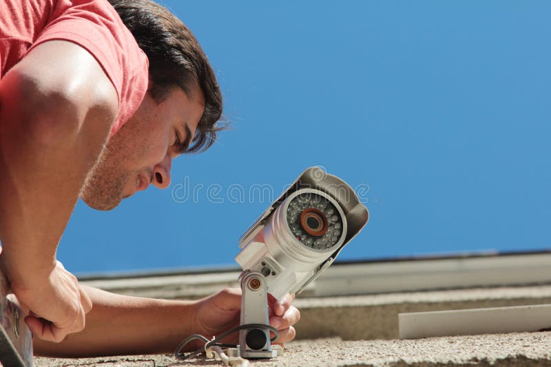 Fixing the security camera stock photo. Image of working - 20298404