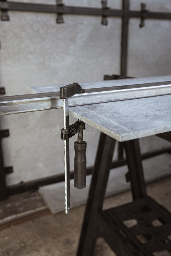 Fixing a Square Metal Pipe with a Metal Clamp and Sheet of Straight ...