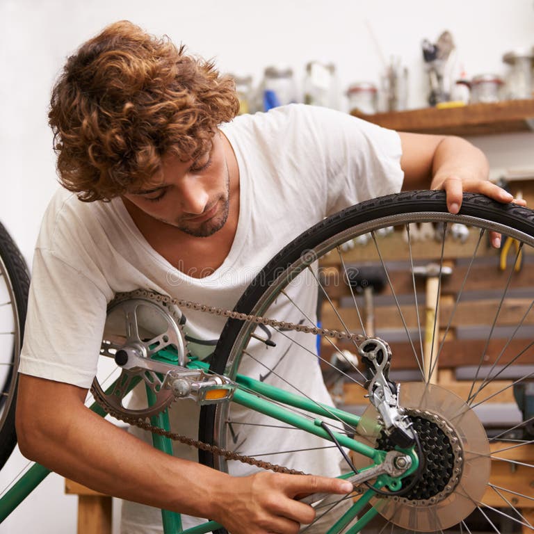 Fixing Things is What I Do Best. a Young Man Fixing a Bicycle. Stock ...