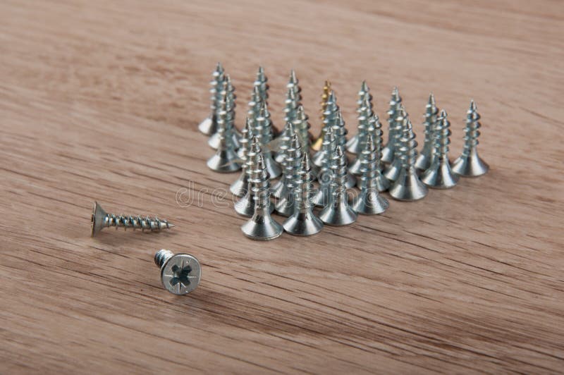 Fixing Tools. Metallic Screws Lay on Wooden Table Stock Image - Image ...