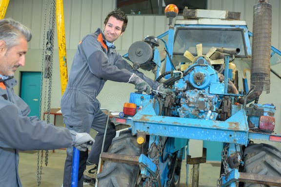They fixing tractor stock photo. Image of grease, farmer - 312437034