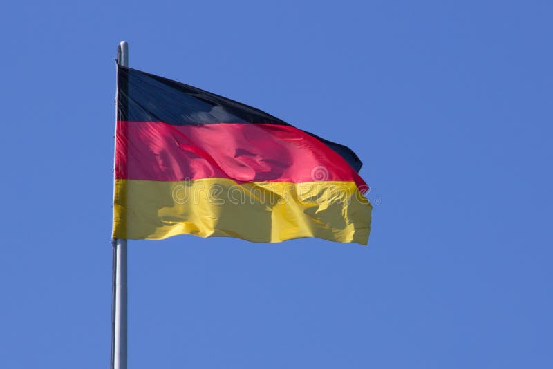 Flag of Germany on Flagpole Against the Blue Sky. Stock Photo - Image ...