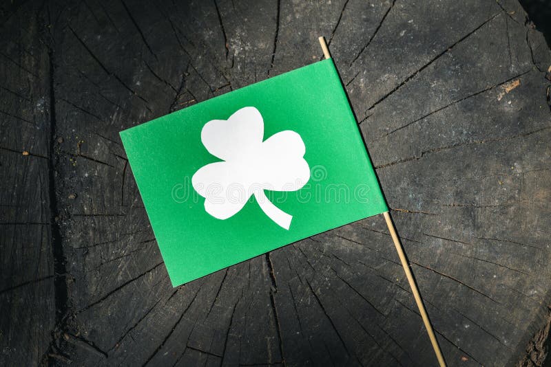 Flag with the Image of Clover Lies on a Stump in the Forest Stock Photo ...