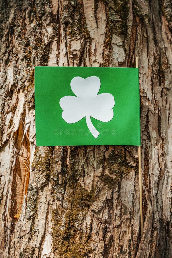 Flag with the Image of Clover on a Tree Trunk Stock Photo - Image of ...