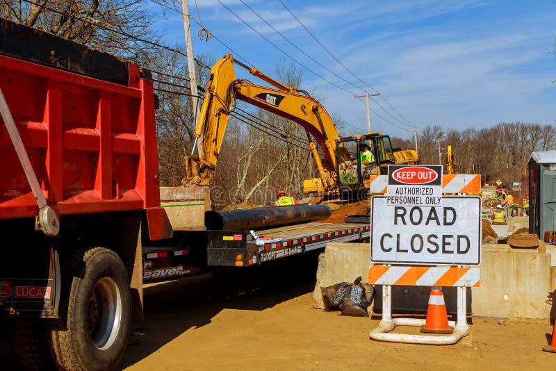 Flag Man Points To a Road Closed Sign on a Highway Editorial Stock ...