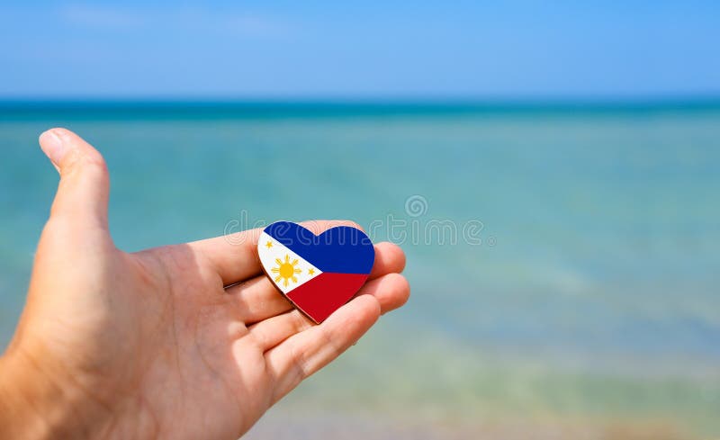 Flag of the Philippines in Hand Against the Sea. Stock Image - Image of ...