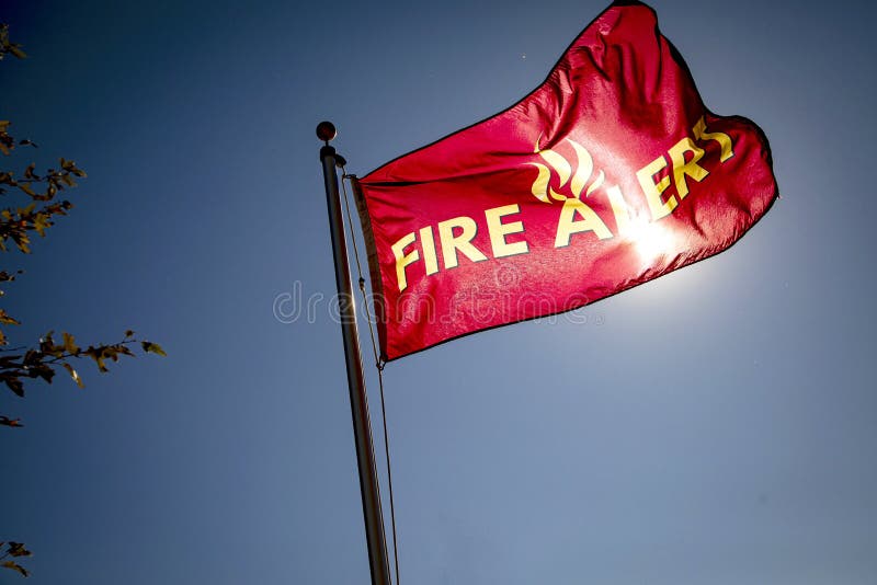Flag Reading `Fire Alert` in Wind Against Blue Sky Stock Photo - Image ...