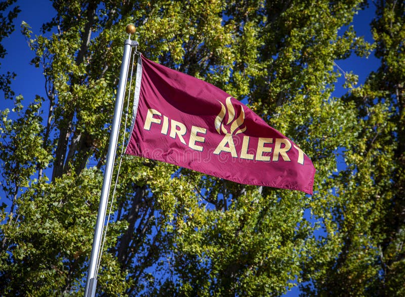 Flag in Wind Reading `Fire Alert`with Aspen Trees in Background Stock ...