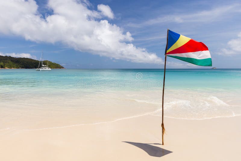 The Flag of Seychelles Mounted on the Beach Waving in Wind Stock Photo ...