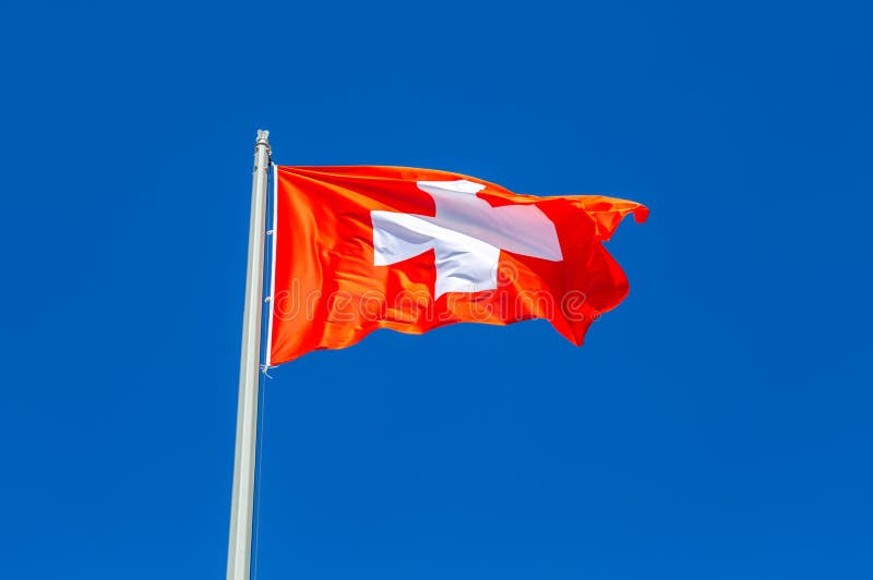 Flag of Switzerland Flying in the Wind Against the Sky Stock Image ...