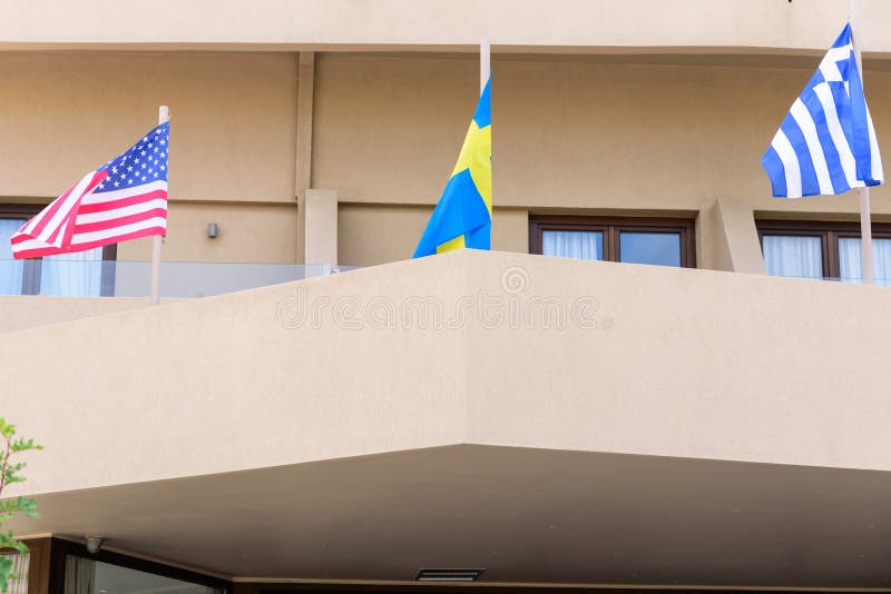 Flags on Balcony of Building in Chania. USA, Sweden, Greece Flags Stock ...