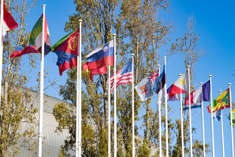 Flags of Countries Fluttering in the Wind Next To Trees Stock Image ...