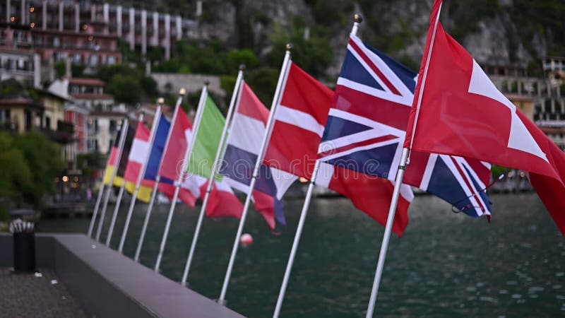Flags of Different Countries Waving in the Wind by Lake Garda Stock ...