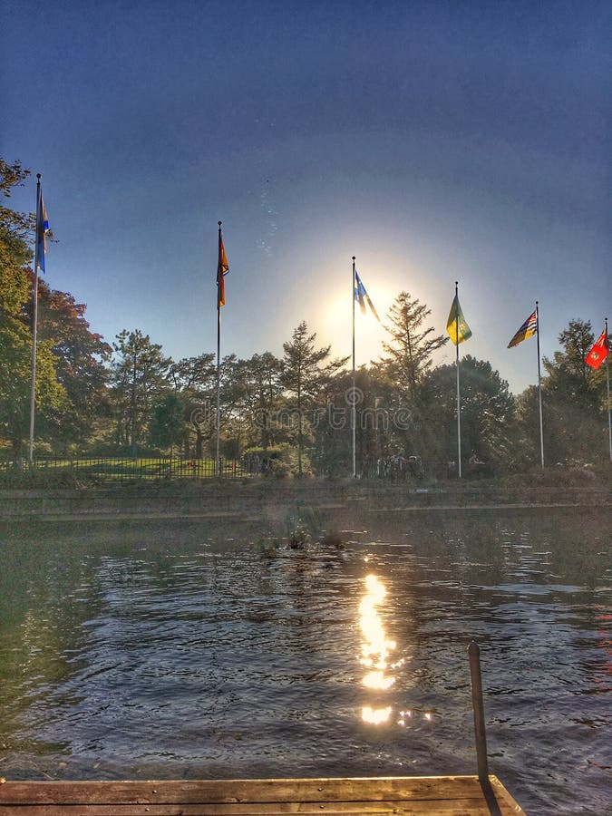 Flags stock photo. Image of water, flags, sunset, island - 85058024