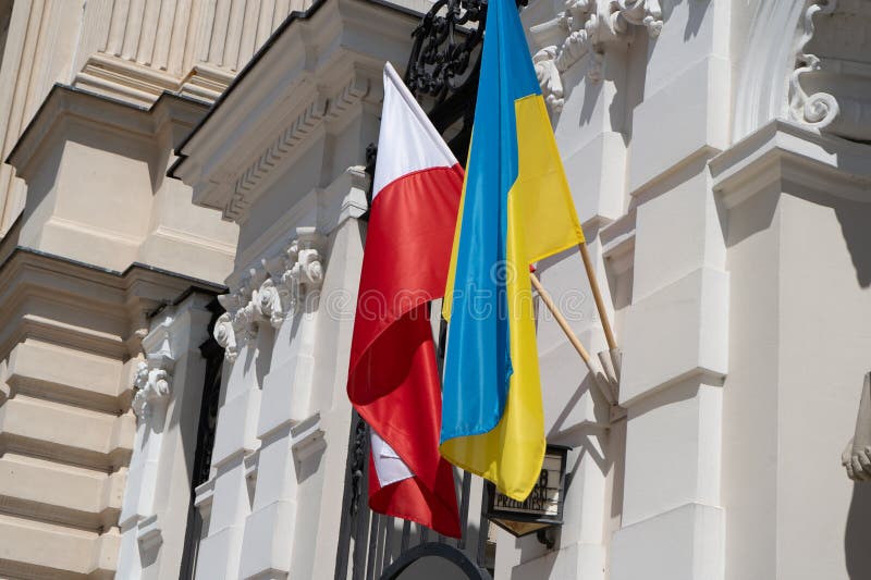 The Flags of Ukraine and Poland Flutter in the Wind. Support and ...