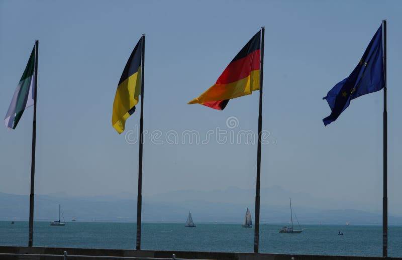 4 Flags in the Wind on the Lake Shore Stock Image - Image of country ...