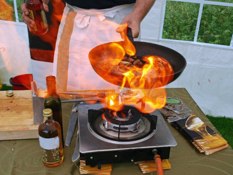 Flambe cook in flames stock image. Image of ethnicity - 6875845