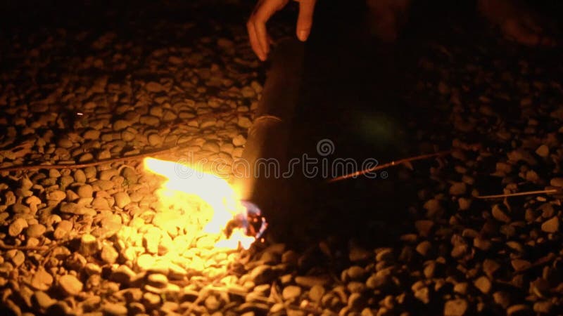 A Flame from the Fire Torch Made by a Bamboo Stick Brightens in the ...