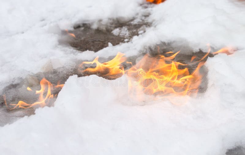 Flame of Fire on White Snow in Winter Stock Photo - Image of fire, heat ...