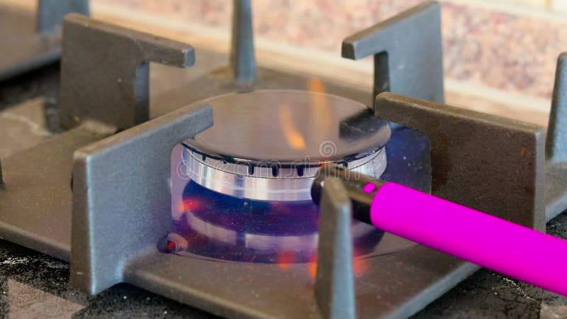The Flame of a Gas Burner on a Stove in the Kitchen is Ignited by a ...