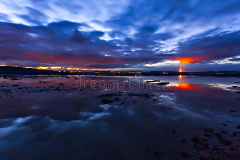 Flame on Horizon of Night Cloudscape Scene Over Water Surface Stock ...