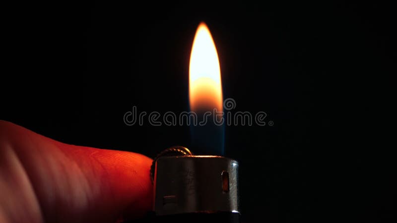 The Flame of a Lighter on a Dark Background is a Close-up. Red Light ...