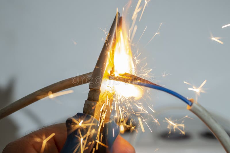 Flame and Sparks with Pliers Cutting Electrical Cables, Fire Hazard ...