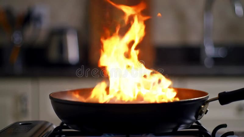 Flames Erupting from a Cooking Pan on a Gas Stove in a Kitchen Setting ...