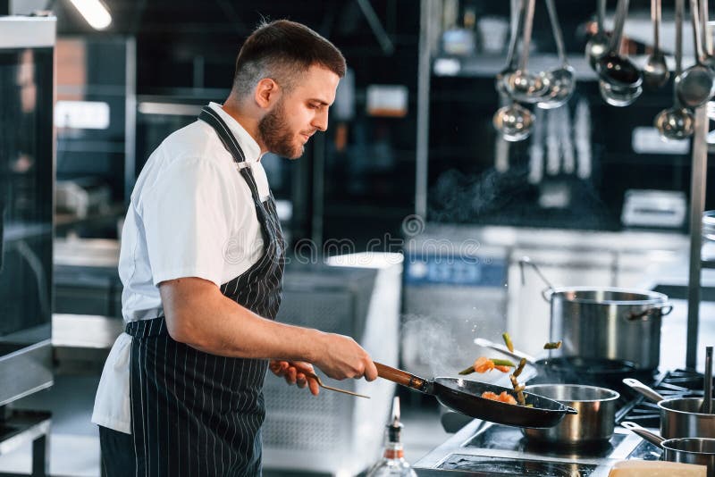 Flames on the Frying Pan. Chef is on the Kitchen Preparing Food Stock ...