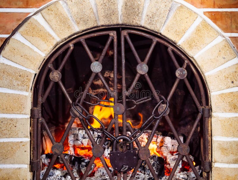 Flaming Firewood in a Chained Fireplace with a Padlock Stock Image ...
