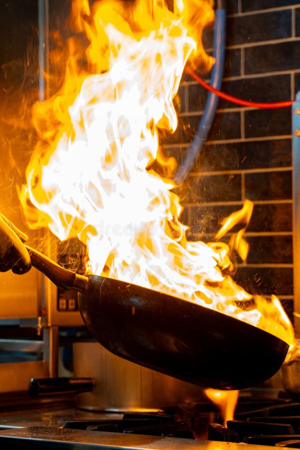 Flaming Pan in a Restaurant Kitchen Stock Photo - Image of fire ...