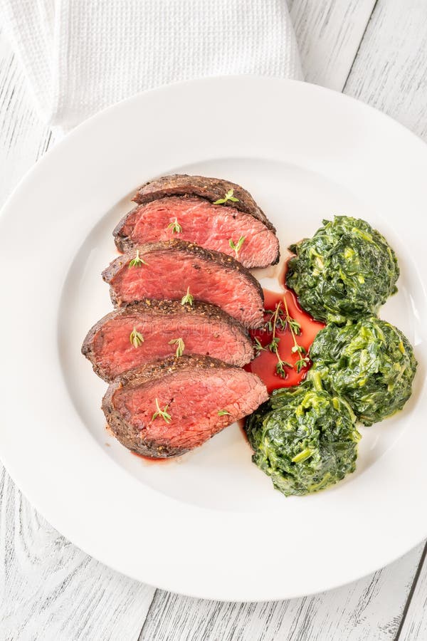 Flank Steak with Creamy Spinach Stock Image - Image of green, white ...