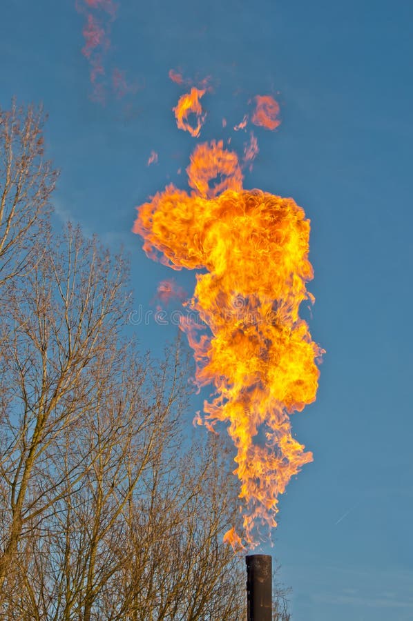 Flaring Flames Against a Blue Sky Stock Photo - Image of dangerous ...