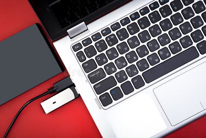 A Flash Drive And A Hard Drive Connected To A Laptop Stock Photo ...
