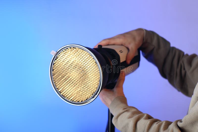 A Flash with the Grid Modifier on Against a Person Stock Photo - Image ...