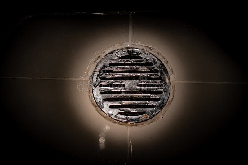 The Flashlight Light Shines on the Floor with a Grille on the Drain ...