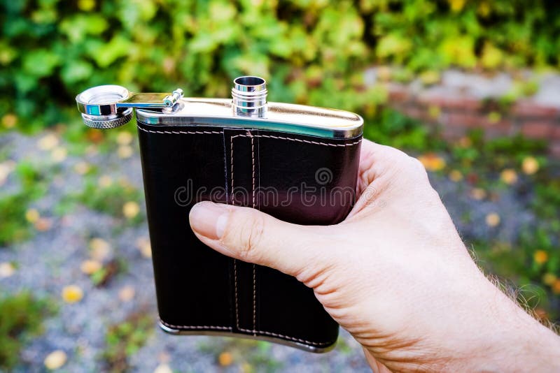 Flask in a Hand stock image. Image of alcoholism, hold - 222318411
