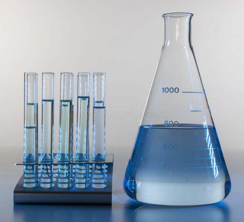 Flask Next To Test Tubes with Blue Liquid Stock Photo - Image of ...