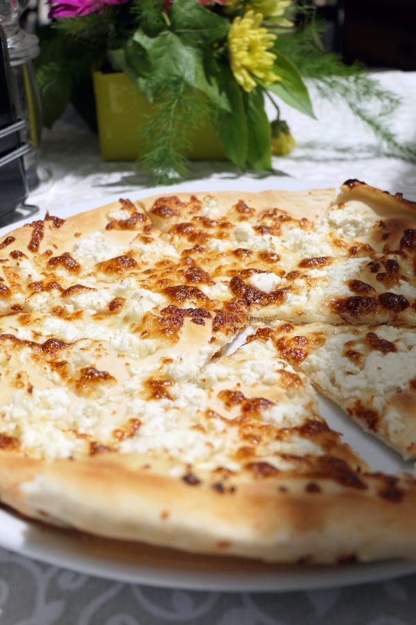 Flat Cheese Bread in a White Plate on a Restaurant Table Stock Photo ...