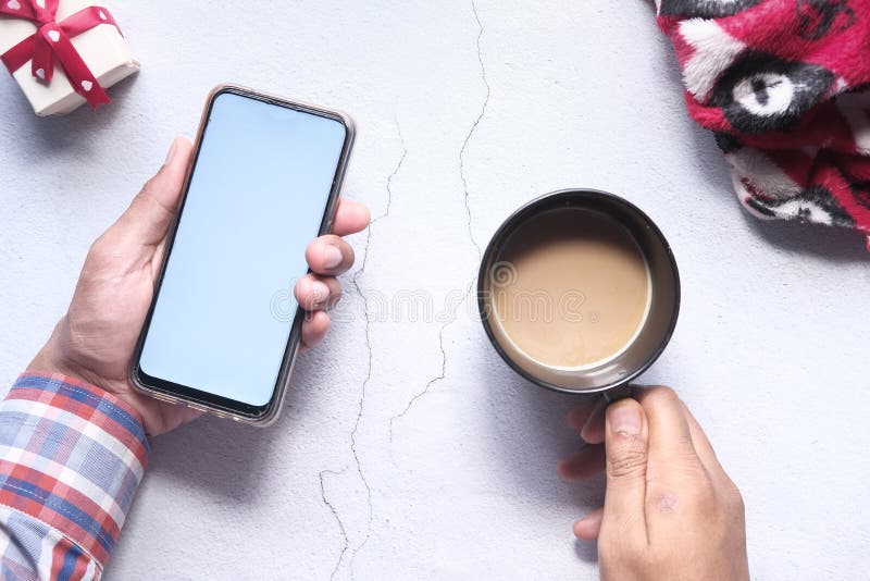 Flat Composition of Hand Holding Smart Phone and Coffee on Table Stock ...