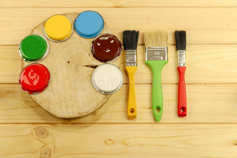 Flat Composition with Multi-colored Paints and Brushes on a Wooden Base ...