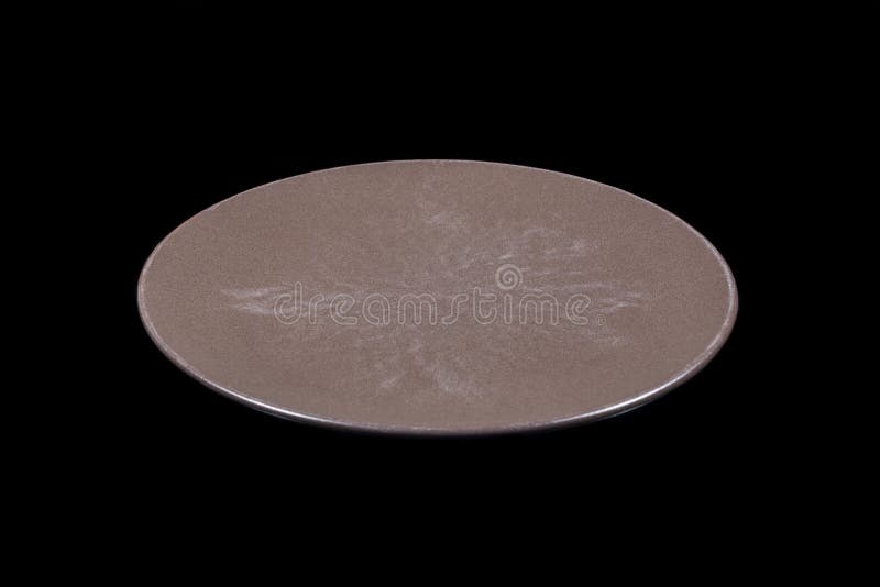 Flat Dark Brown Plate on Black Background from Side Stock Photo - Image ...