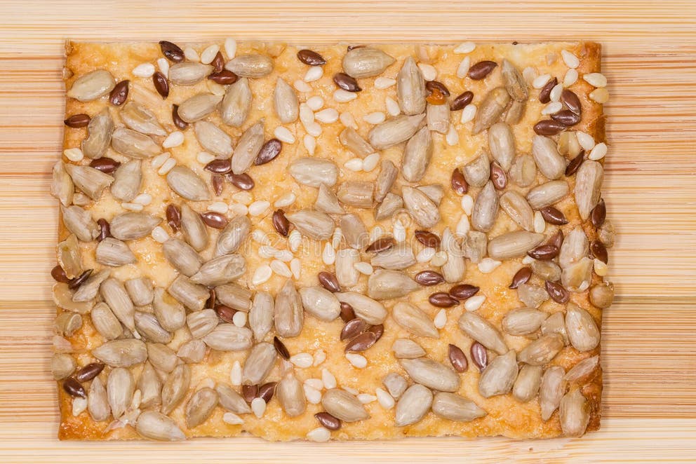 Flat Flaky Cookie with Different Seeds on a Wooden Surface Stock Image ...