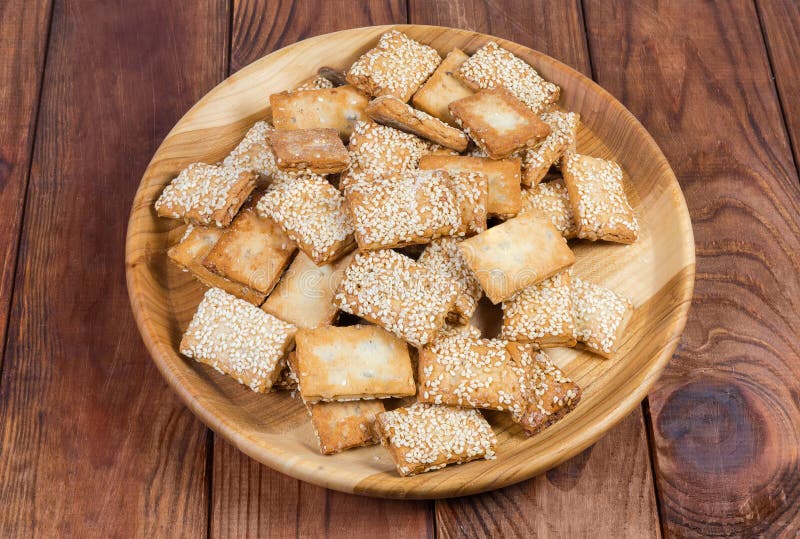 Flat Flaky Sesame Cookies on Wooden Dish on Rustic Table Stock Photo ...