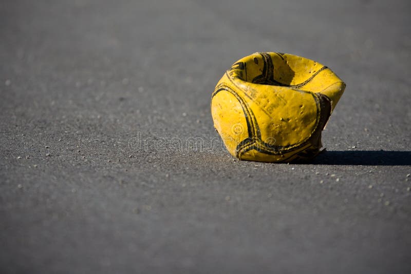 Flat Football on the Street Stock Photo - Image of shadow, yellow: 4517140