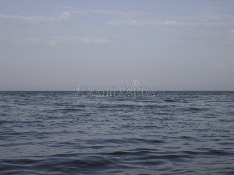 A Flat Horizon between the Sky and the Sea at Sunset on a Clear Day ...