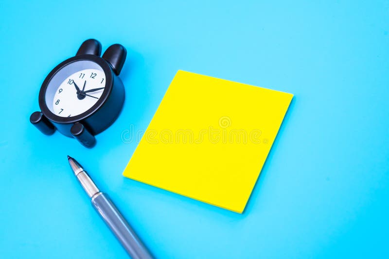 Flat Lay of an Alarm Clock, Pen and Yellow Paper To Write Any Text ...